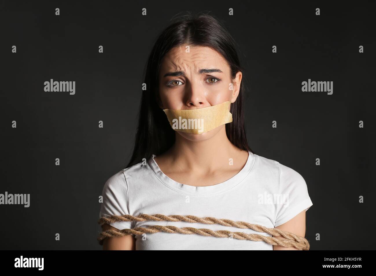 Female hostage on dark background Stock Photo - Alamy