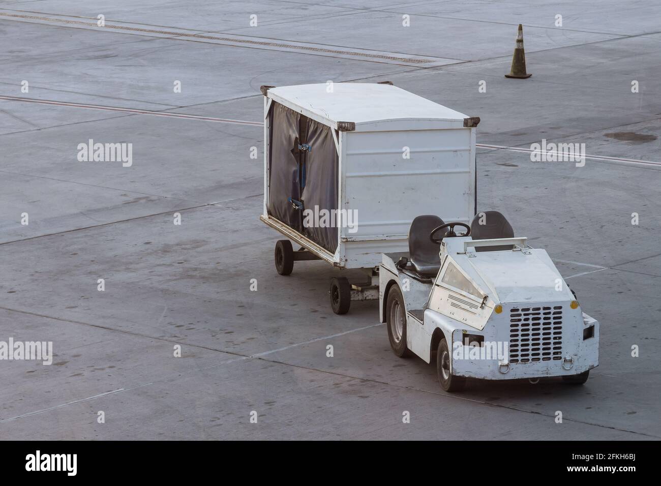 Vehicle for cargo on wait for transport to airplane at airport runway ...