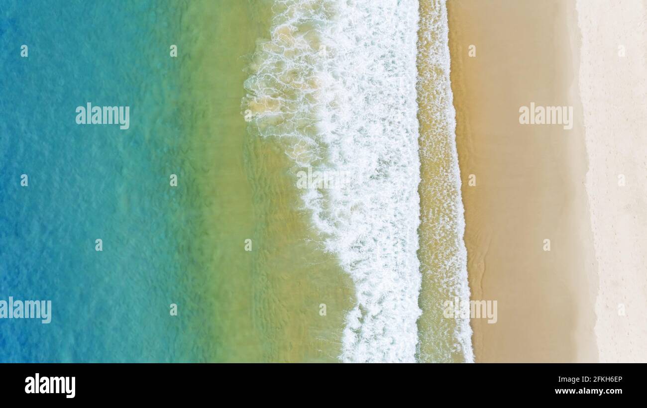 Aerial view of the Gradient color of Ocean surface with waves washing ...