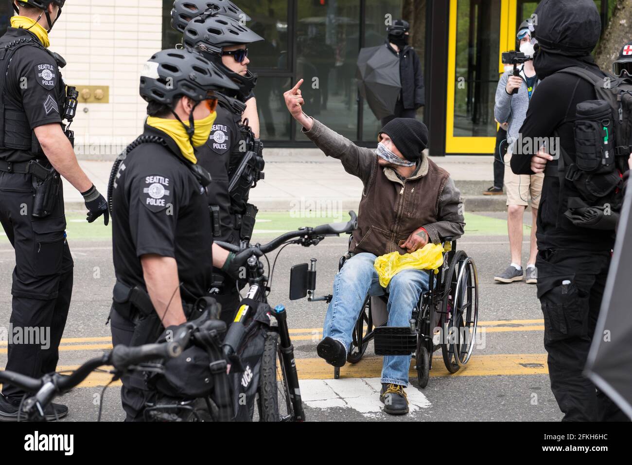 Seattle, USA. 1st May, 2021. Mid-day a protestor in a wheel chair ...