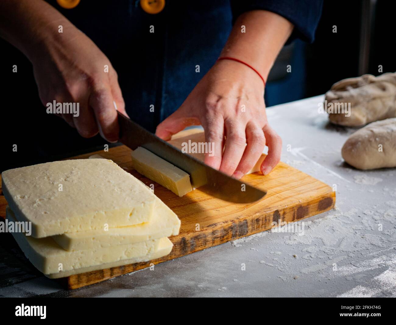 Woman's Hands Cutting Chesse in a Wooden Table on the Metal Table Stock ...