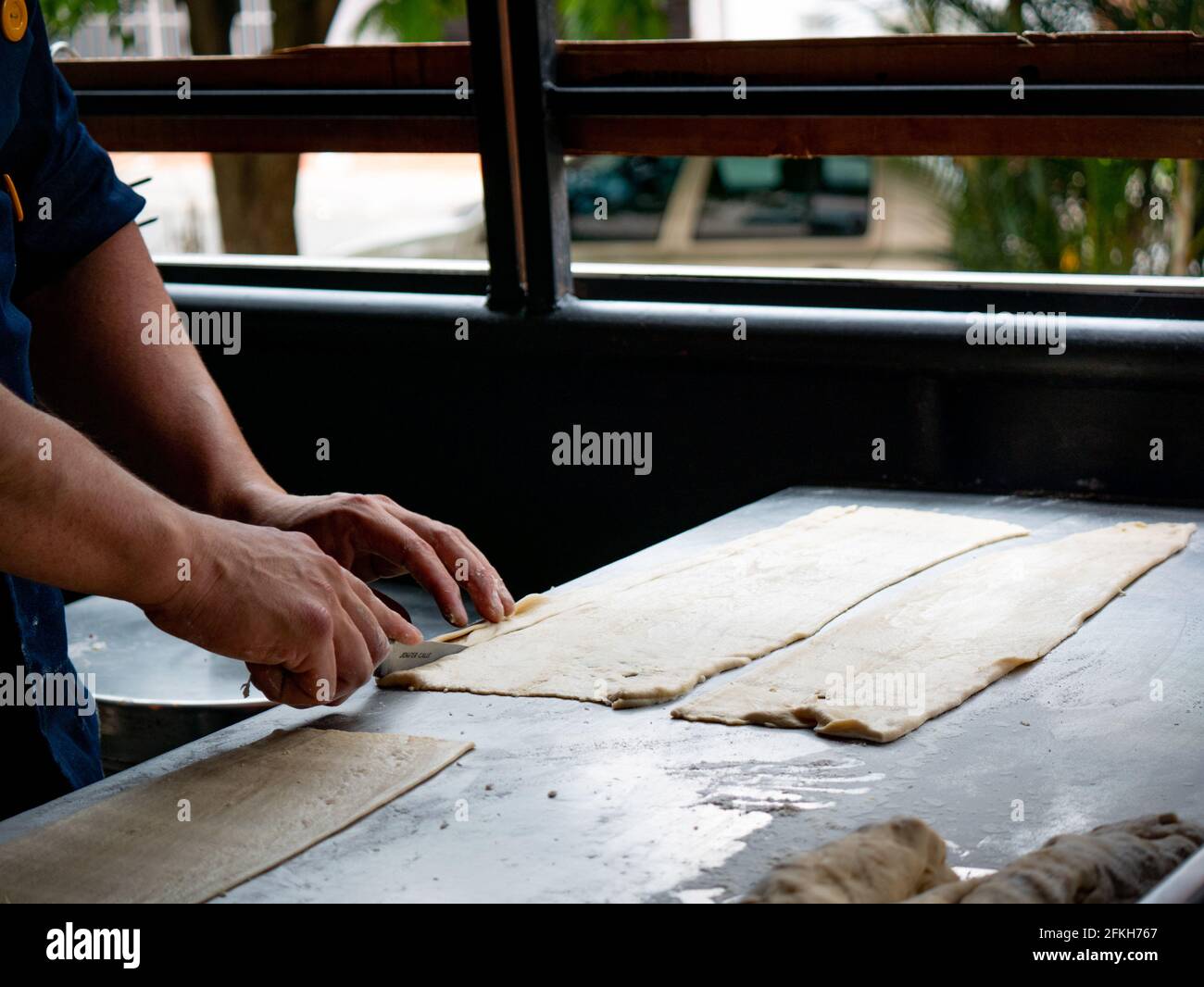 Woman's Hands Cutting some Flour Dough on the Metal Table Stock Photo ...