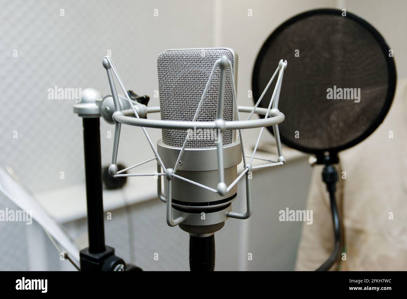 Professional microphone on the background of the light wall. Studio ...