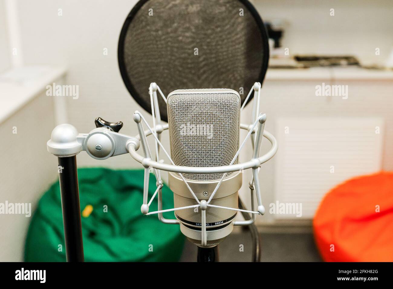 Professional microphone on the background of the light wall. Studio ...