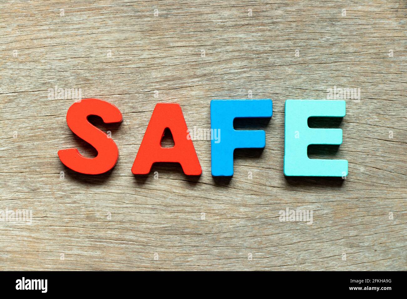 Color alphabet letter in word safe on wood background Stock Photo - Alamy