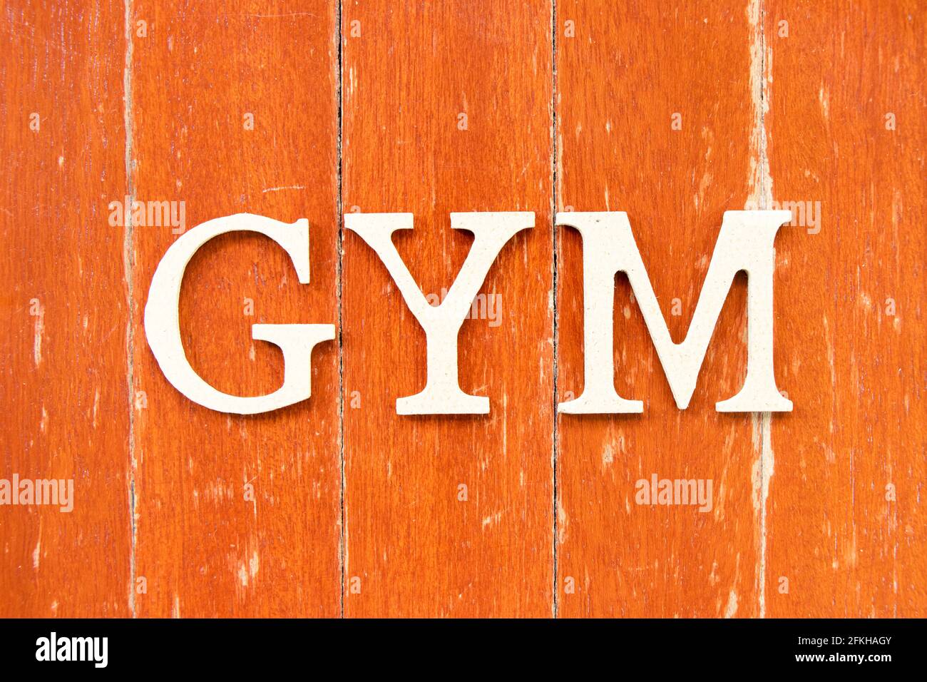 Alphabet letter in word gym on old red color wood plate background ...
