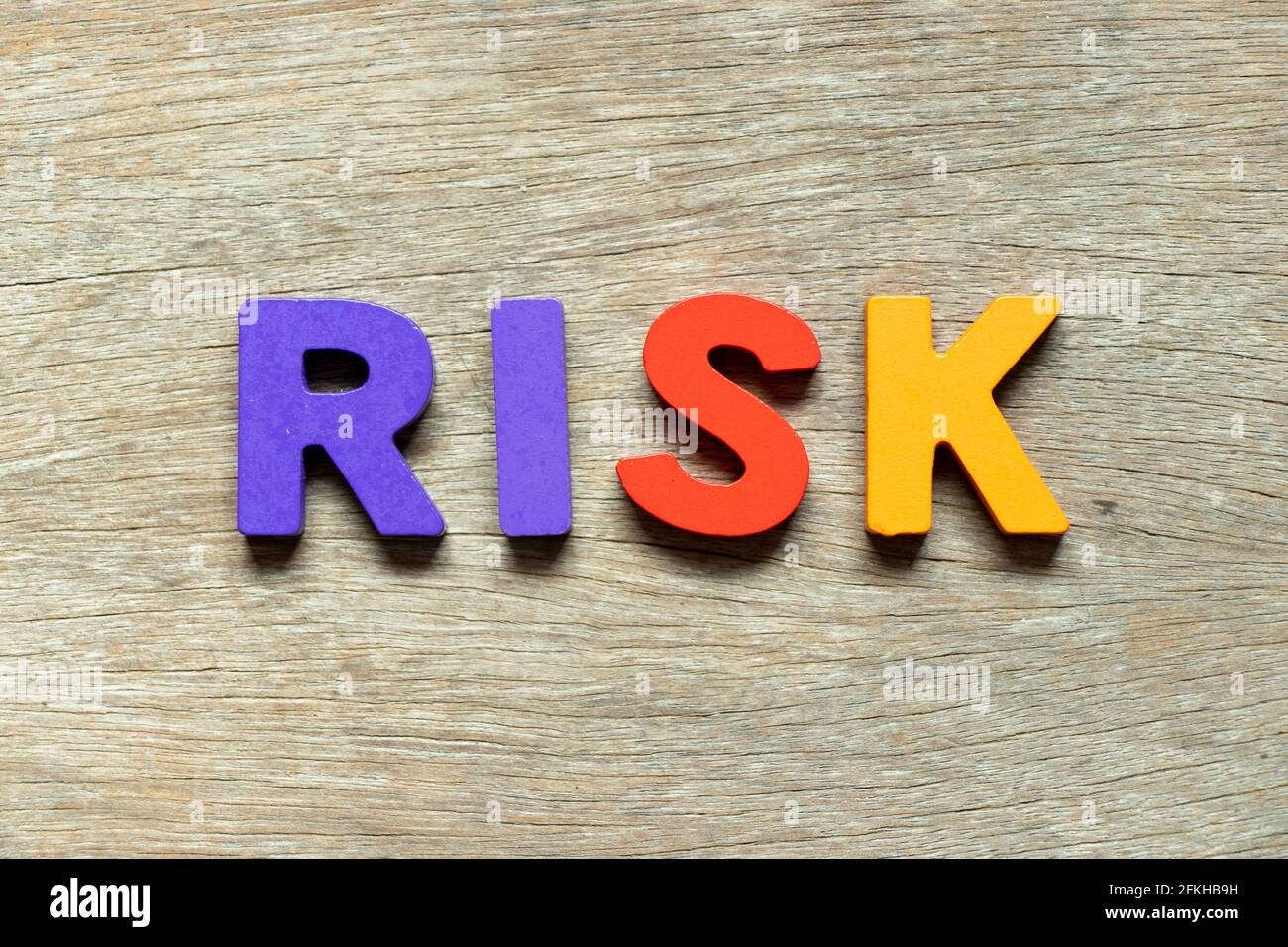 Color alphabet letter in word risk on wood background Stock Photo - Alamy