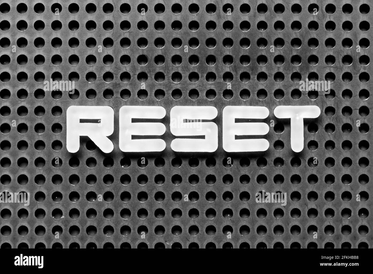 White alphabet letter in word reset on black pegboard background Stock ...