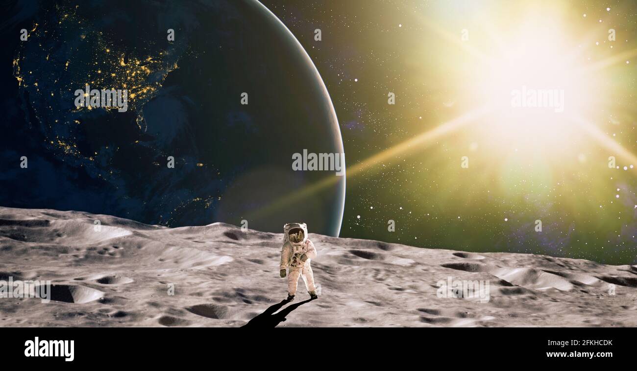 Astronaut looks up at an alien sun that illuminates the barren world he ...