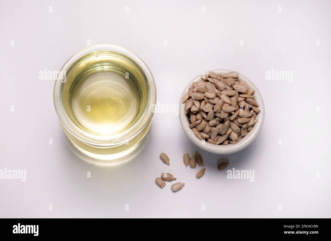 Sunflower oil and sunflower seeds isolated on white background ...