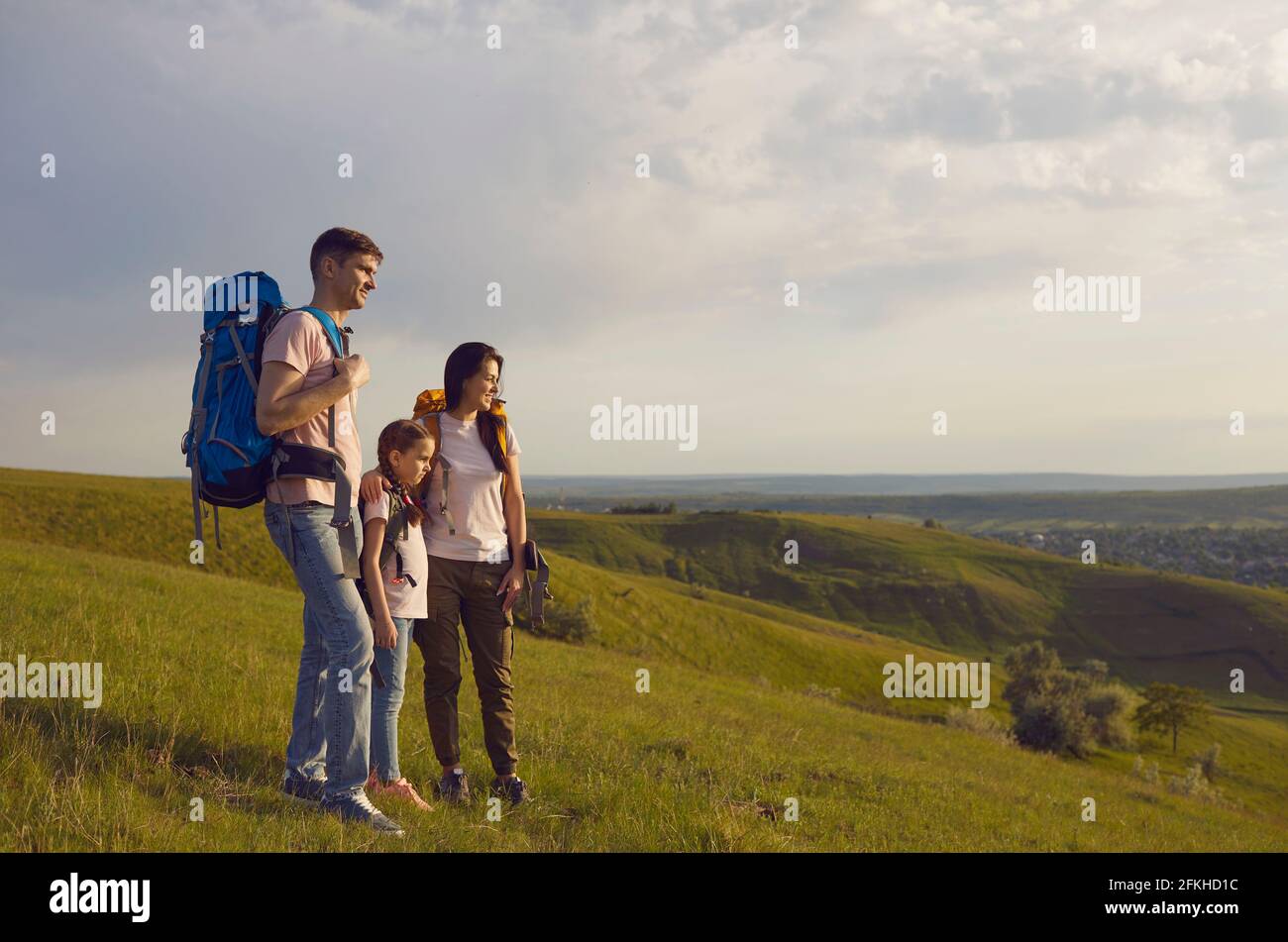 Family of backpackers in mountainous valley in summer nature Stock ...
