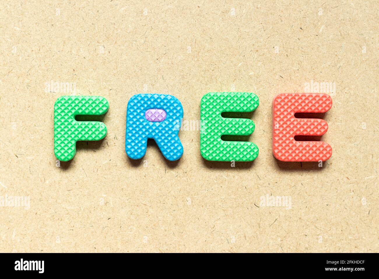 Foam alphabet letter in word free on wood background Stock Photo - Alamy