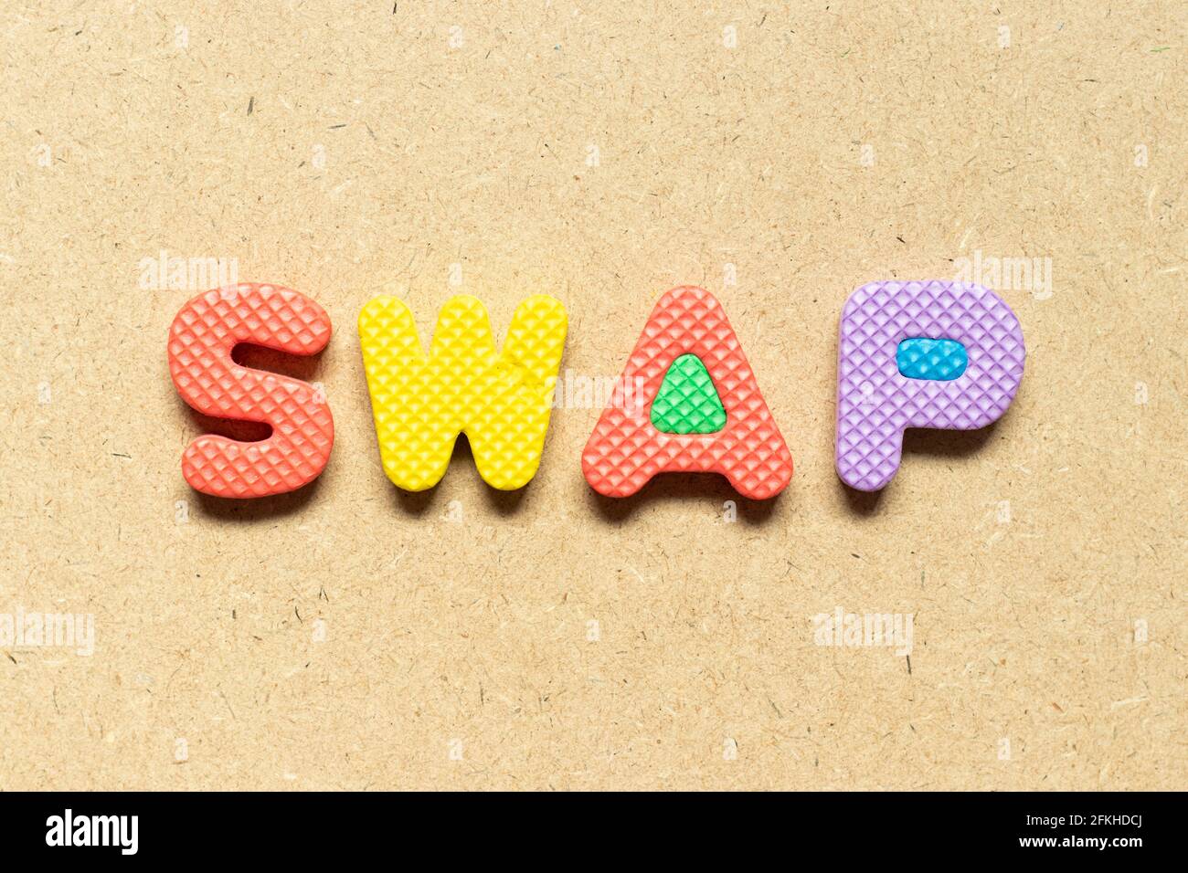 Foam alphabet letter in word swap on wood background Stock Photo - Alamy