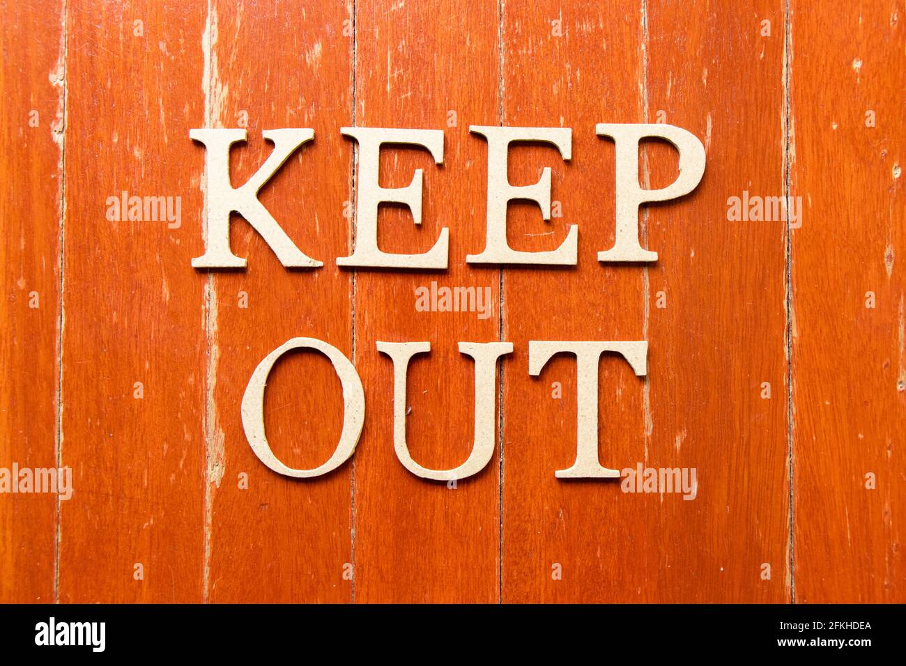 Alphabet letter in word keep out on old red color wood plate background ...