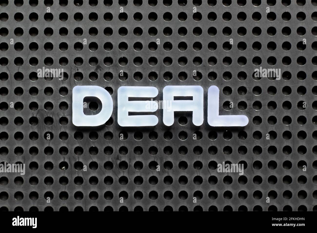 White color letter in word deal on black pegboard background Stock ...