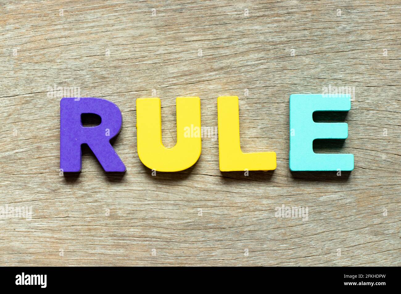 Color alphabet letter in word rule on wood background Stock Photo - Alamy