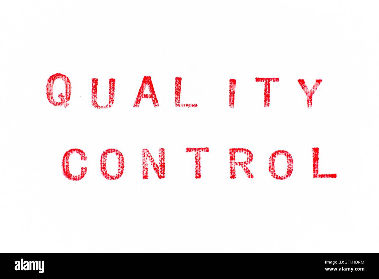 Red color rubber stamp in word quality control on white paper ...