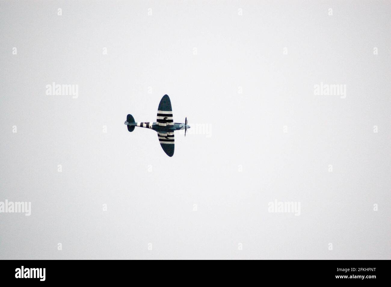 Spitfire at Jersey Air show fast speed stripes war clouds cloud tail ...