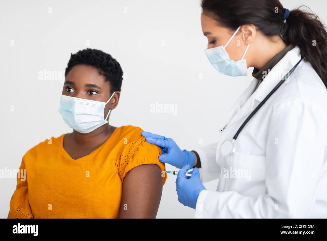 Woman getting vaccine shot by doctor hi-res stock photography and ...