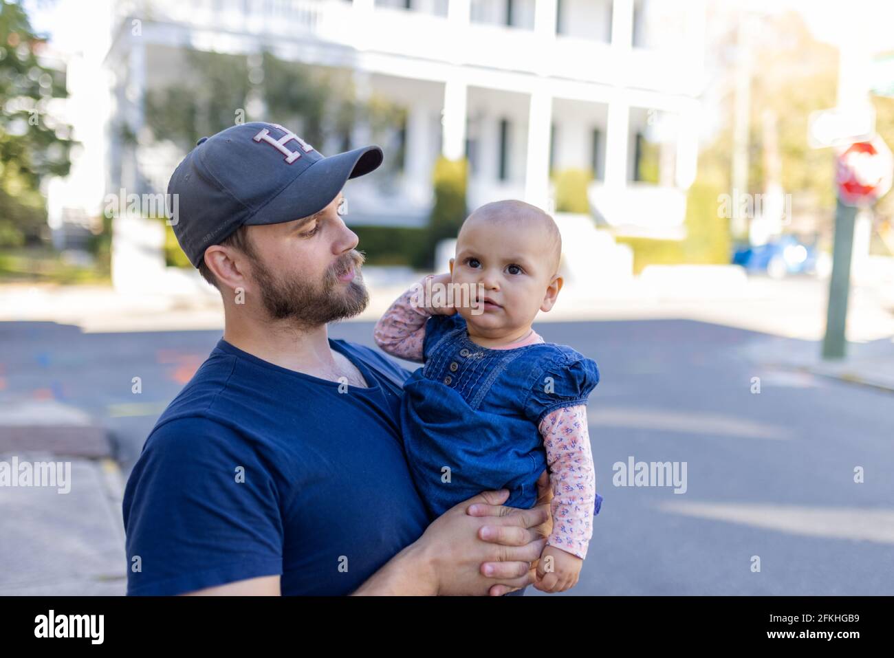 Bearded father holding his cute happy baby with blurry background Stock ...