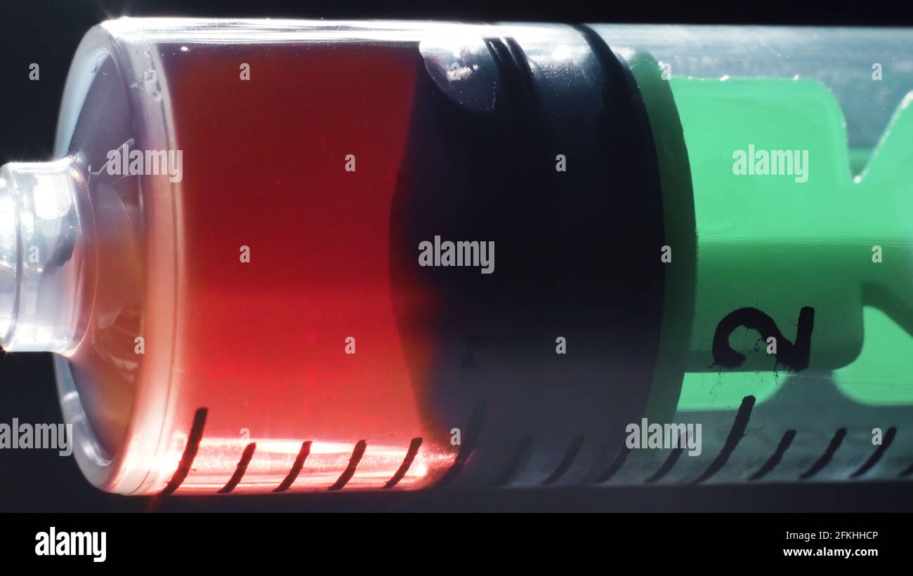 Close-up photo of medical syringe and red drug Stock Photo - Alamy