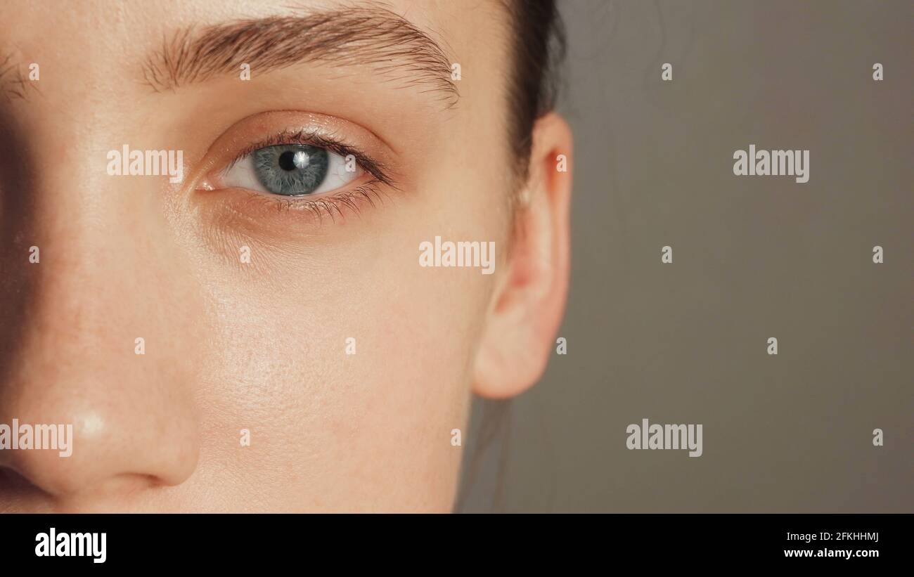 Photo of woman looking at camera, half face Stock Photo - Alamy