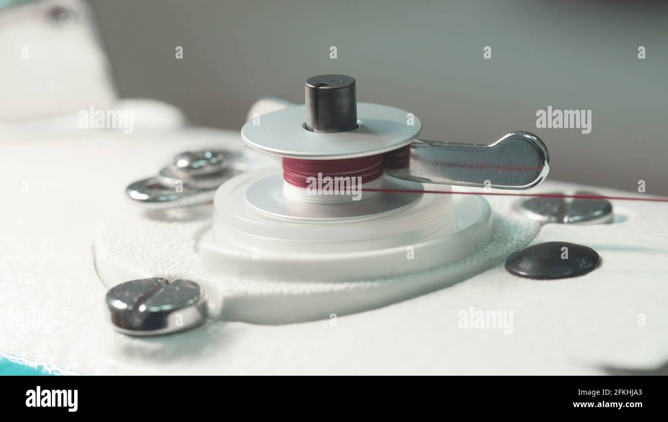 Close-up photo of spinning bobbin of thread Stock Photo - Alamy