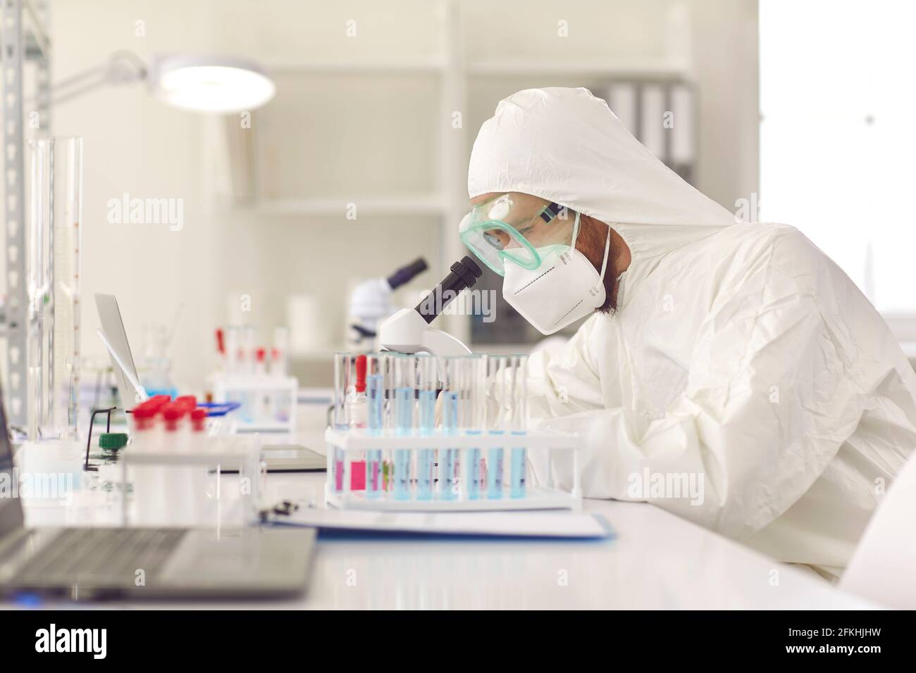 Laboratory scientist in protective uniform working with samples on ...