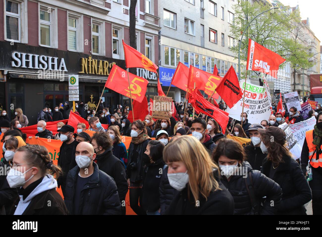Berlin, Germany - May 01, 2021: Protesters holding a banners and flags ...