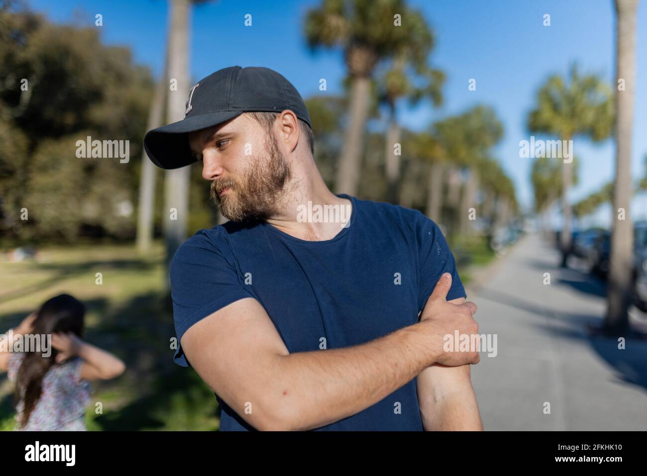 Bearded man standing with palm trees and blue sky as background Stock ...