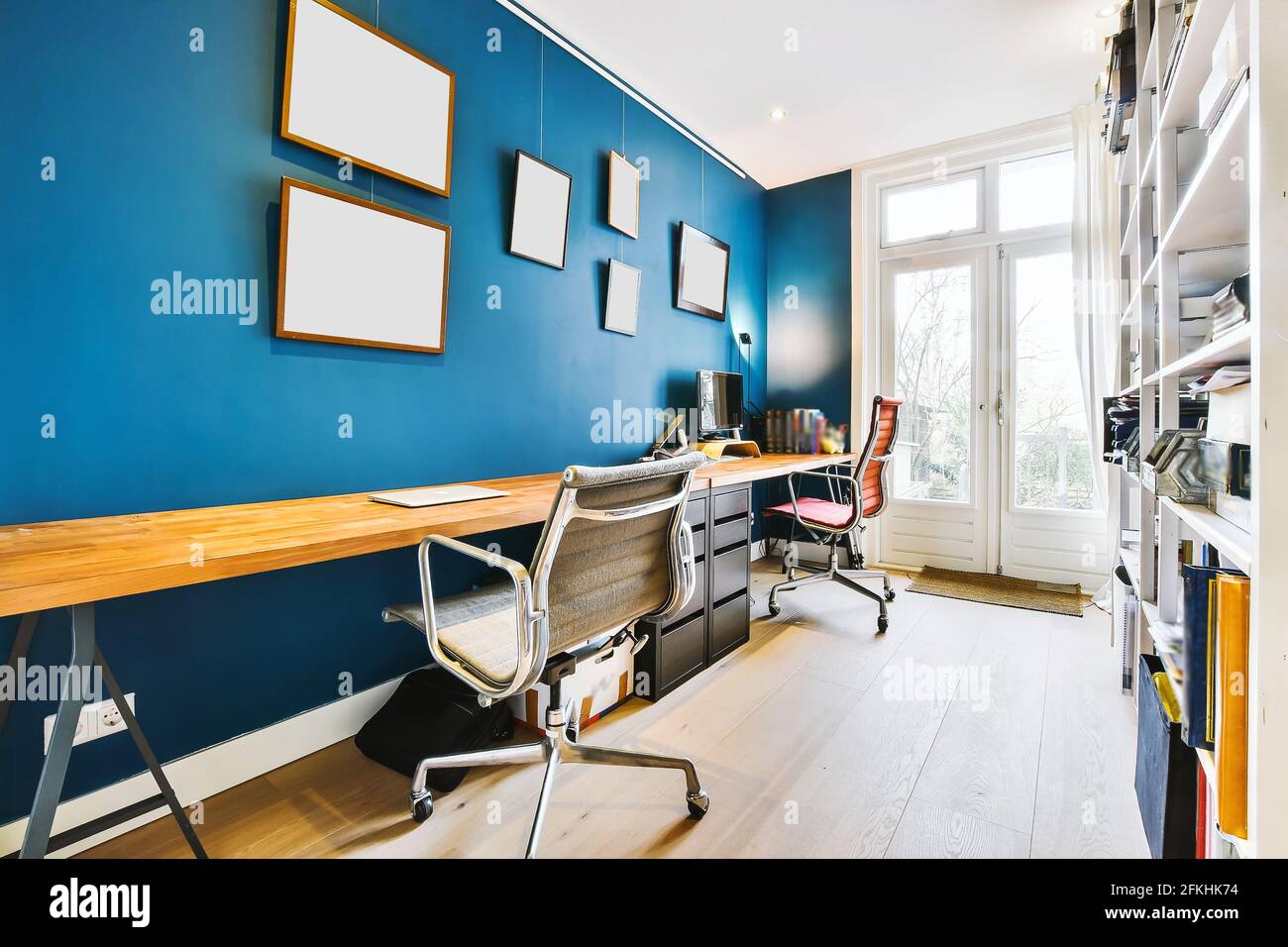 Interior of modern office with wooden table and blue wall Stock Photo ...