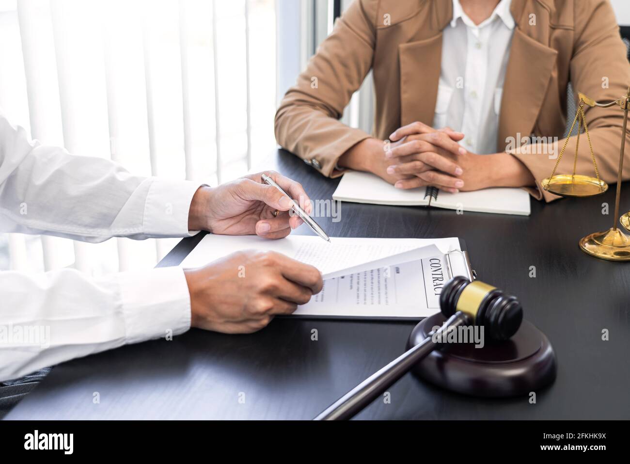 lawyer or judge meeting with client consulting help discussing contract ...