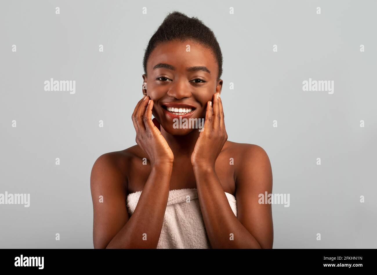 Rejuvenation concept. Cute african american lady touching her perfect ...
