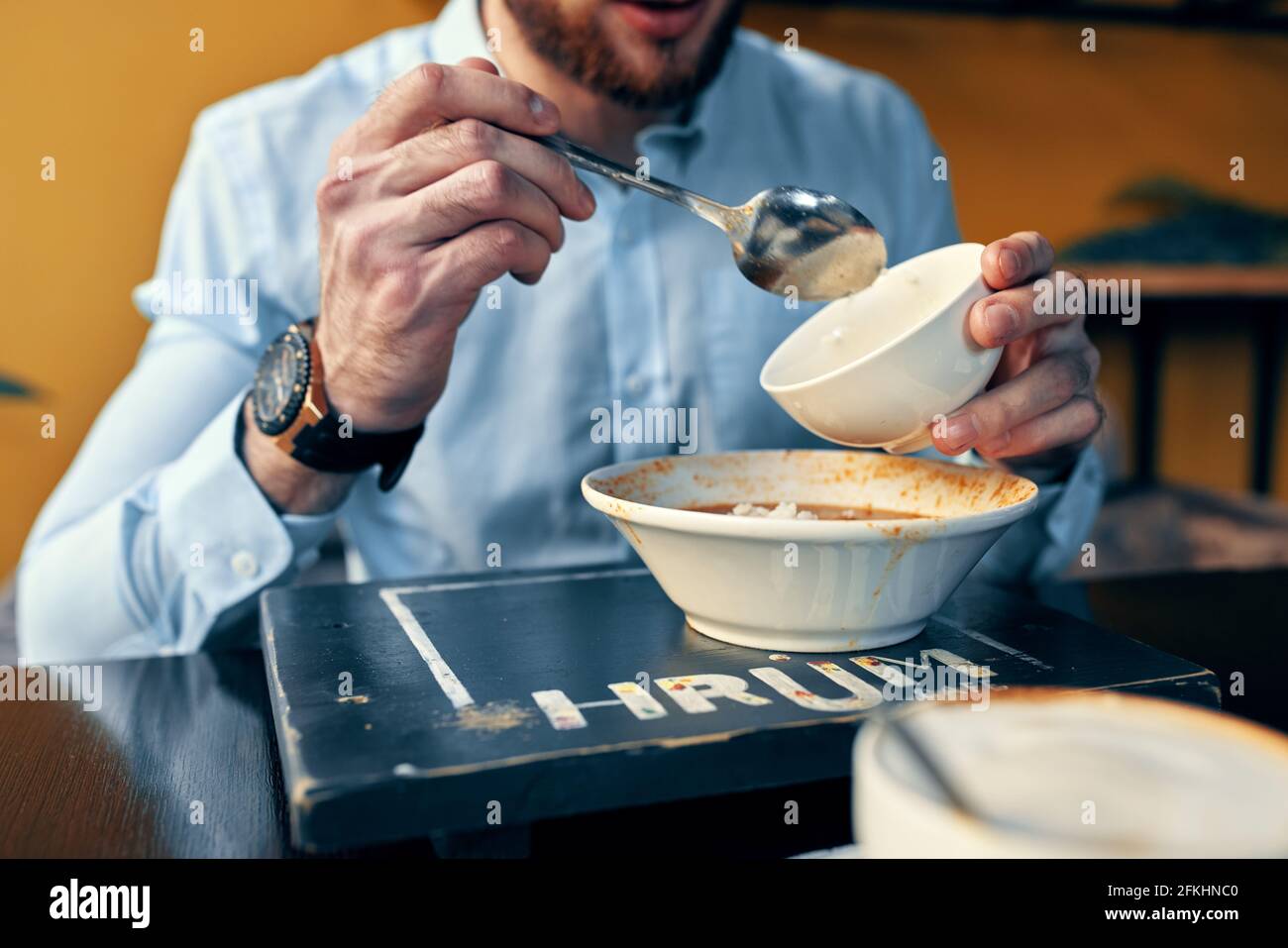 Man eating borscht and pilaf cafe restaurant interior business finance ...
