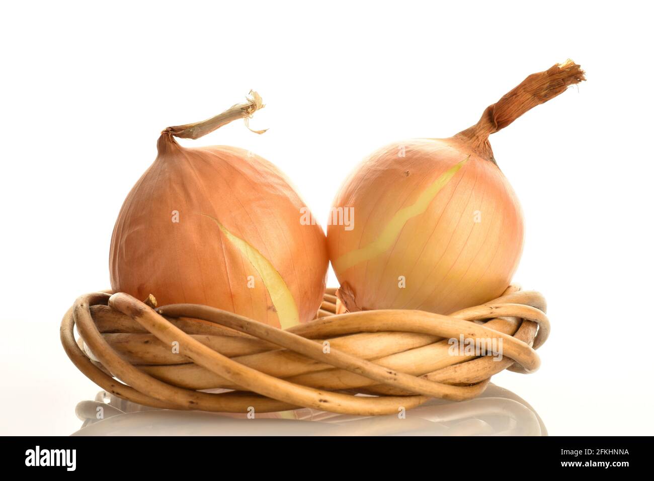 Two round fragrant onions with a vine wreath, close-up, isolated on ...