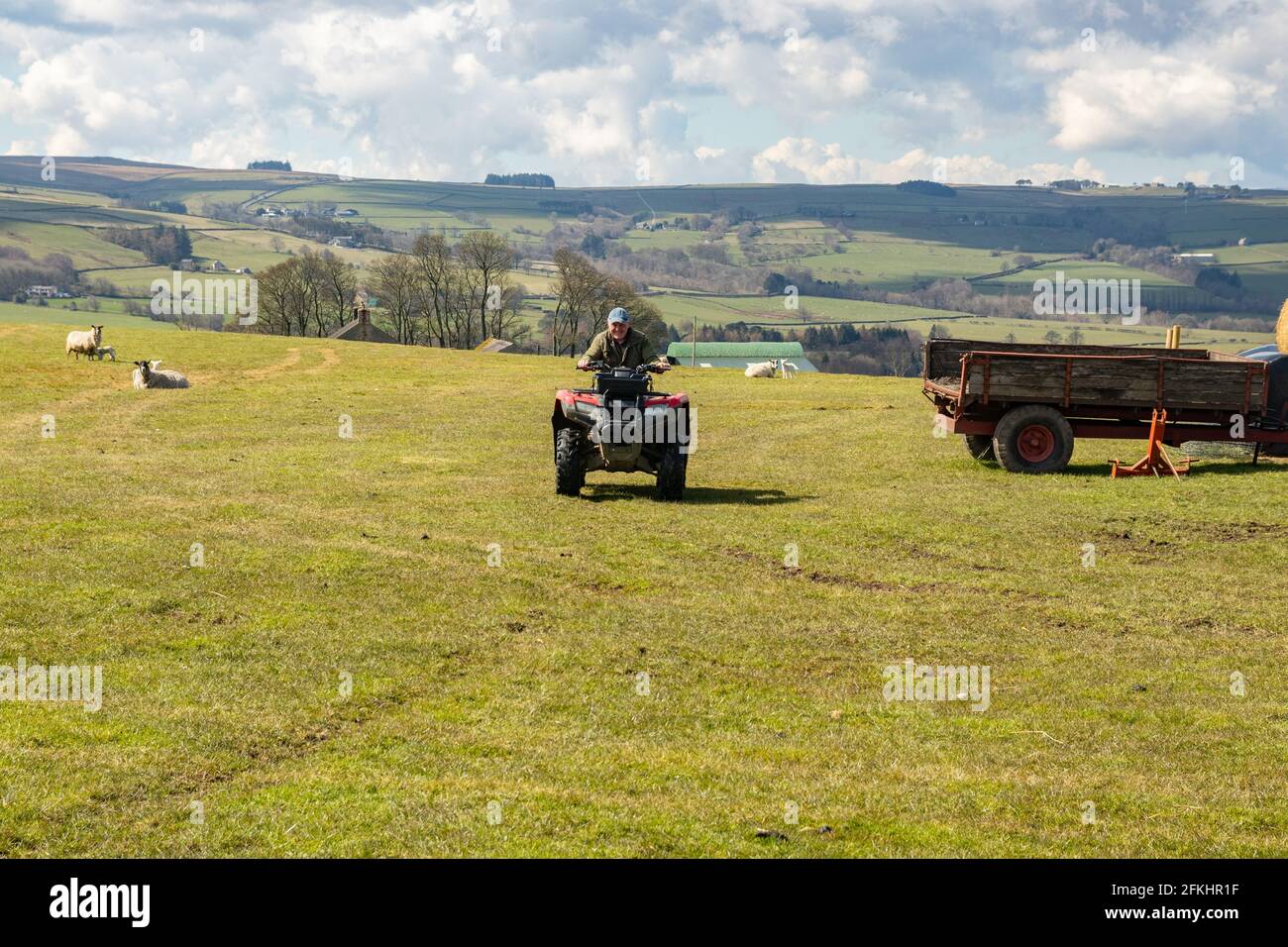 farmer riding ATV quad bike towards camera Stock Photo - Alamy