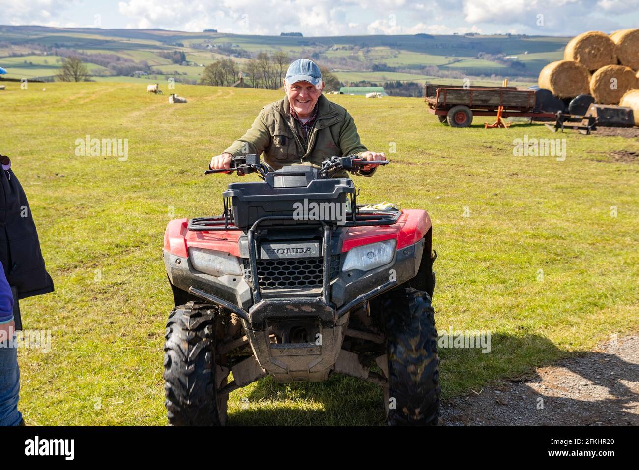 farmer riding ATV quad bike towards camera Stock Photo - Alamy