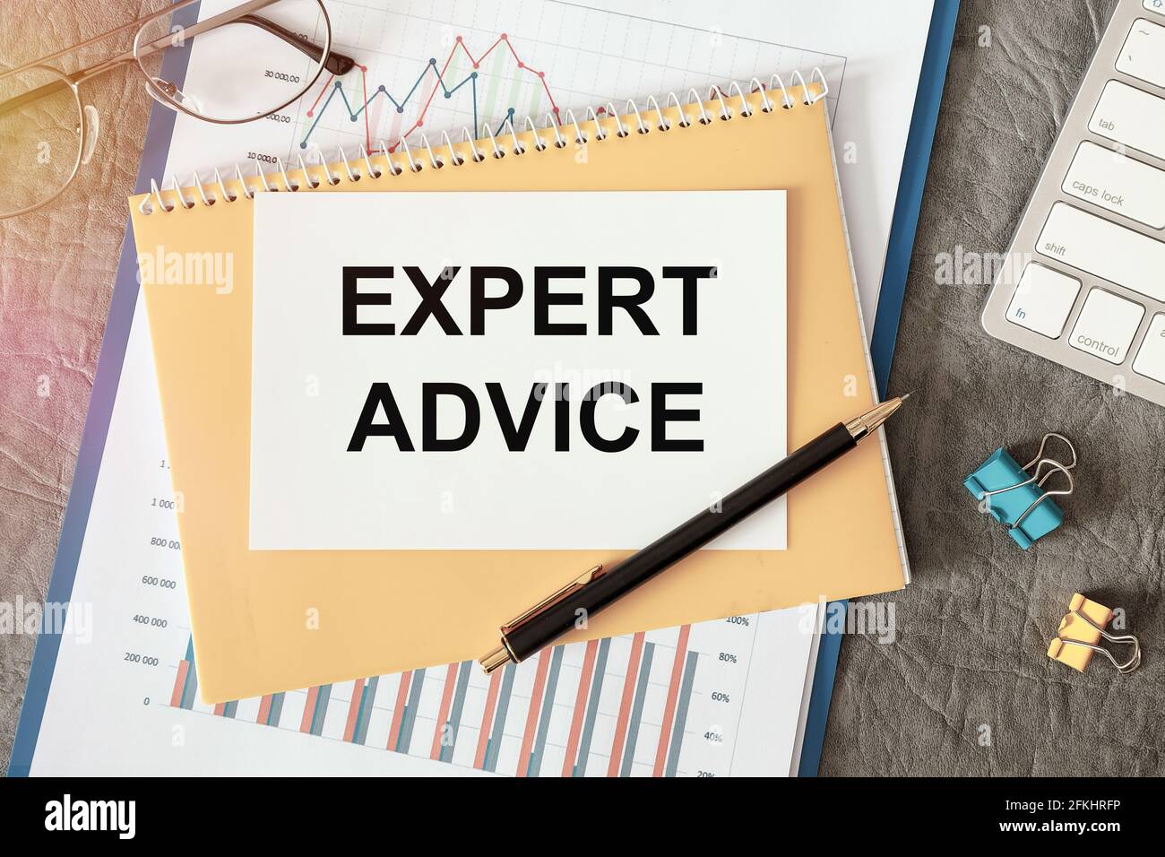 EXPERT ADVICE is written in a document on the office desk with office ...