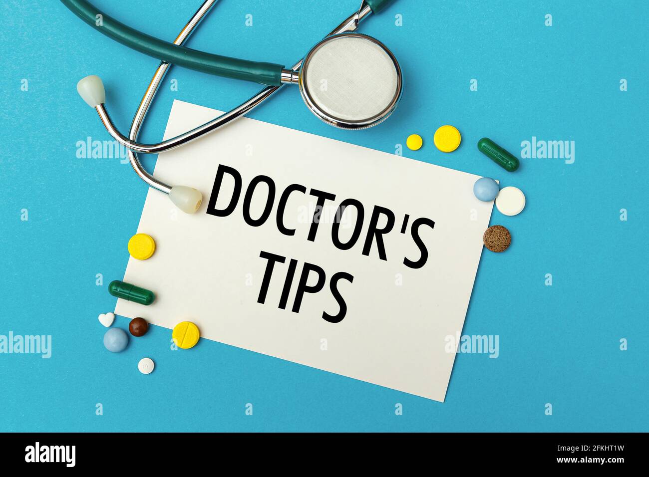 Card with text Doctor's tips, pills and stethoscope, medical concept ...