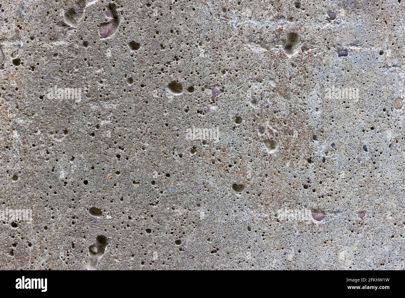 A flat grey concrete textured surface covered in air bubbles Stock ...