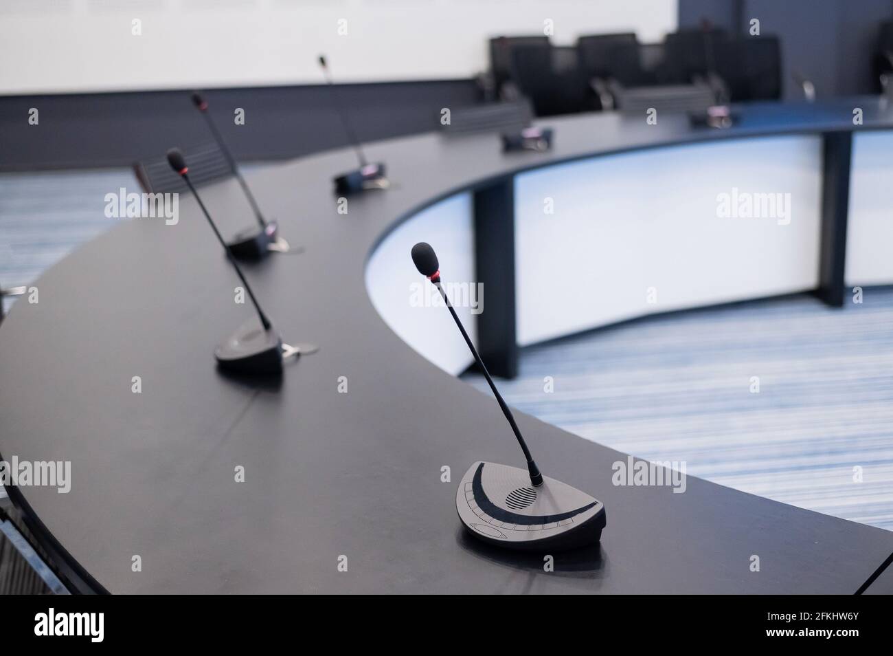 Close-up of microphones in an empty meeting room at a press conference ...