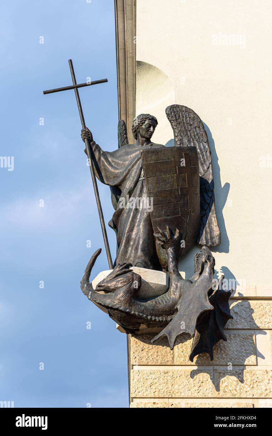 A statue of the archangel Saint Michael with a Hungarian coat of arms ...