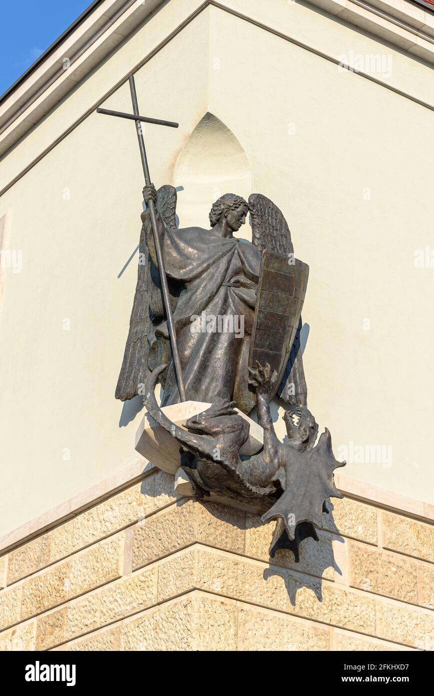 A statue of the archangel Saint Michael with a Hungarian coat of arms ...