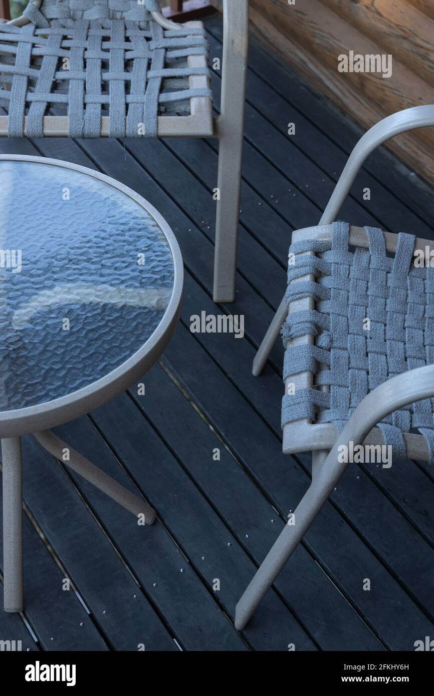 Abstract Selective focus image of a glass table and chairs depicting ...