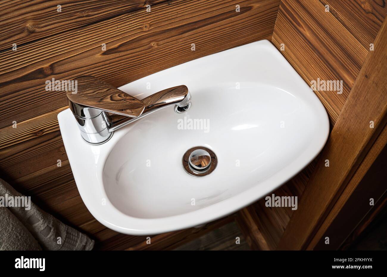 Small white wash basin, wooden walls around, closeup detail Stock Photo ...
