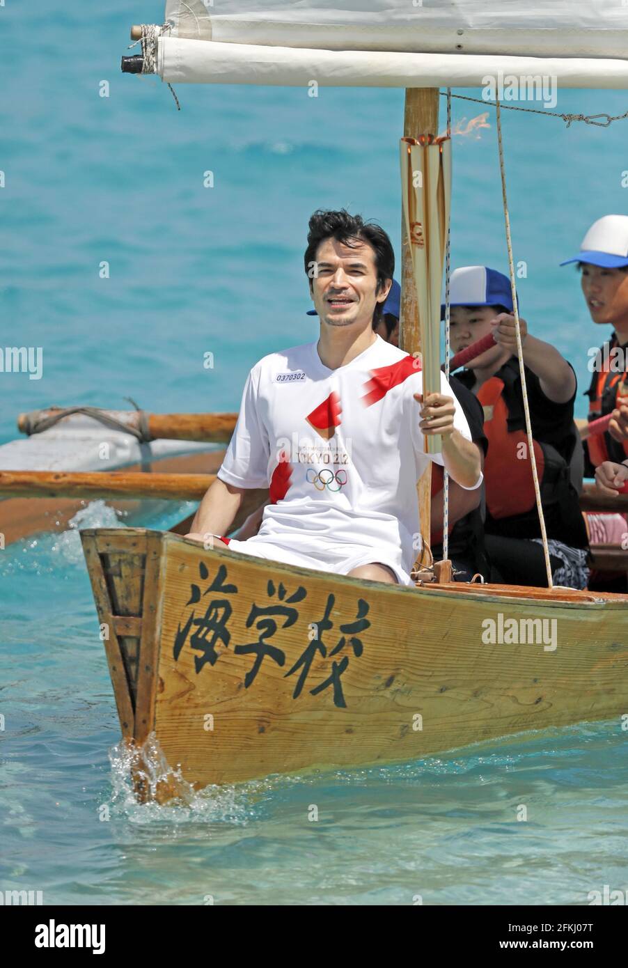 Model and actor Shogen carries the Olympic flame on a traditional ...