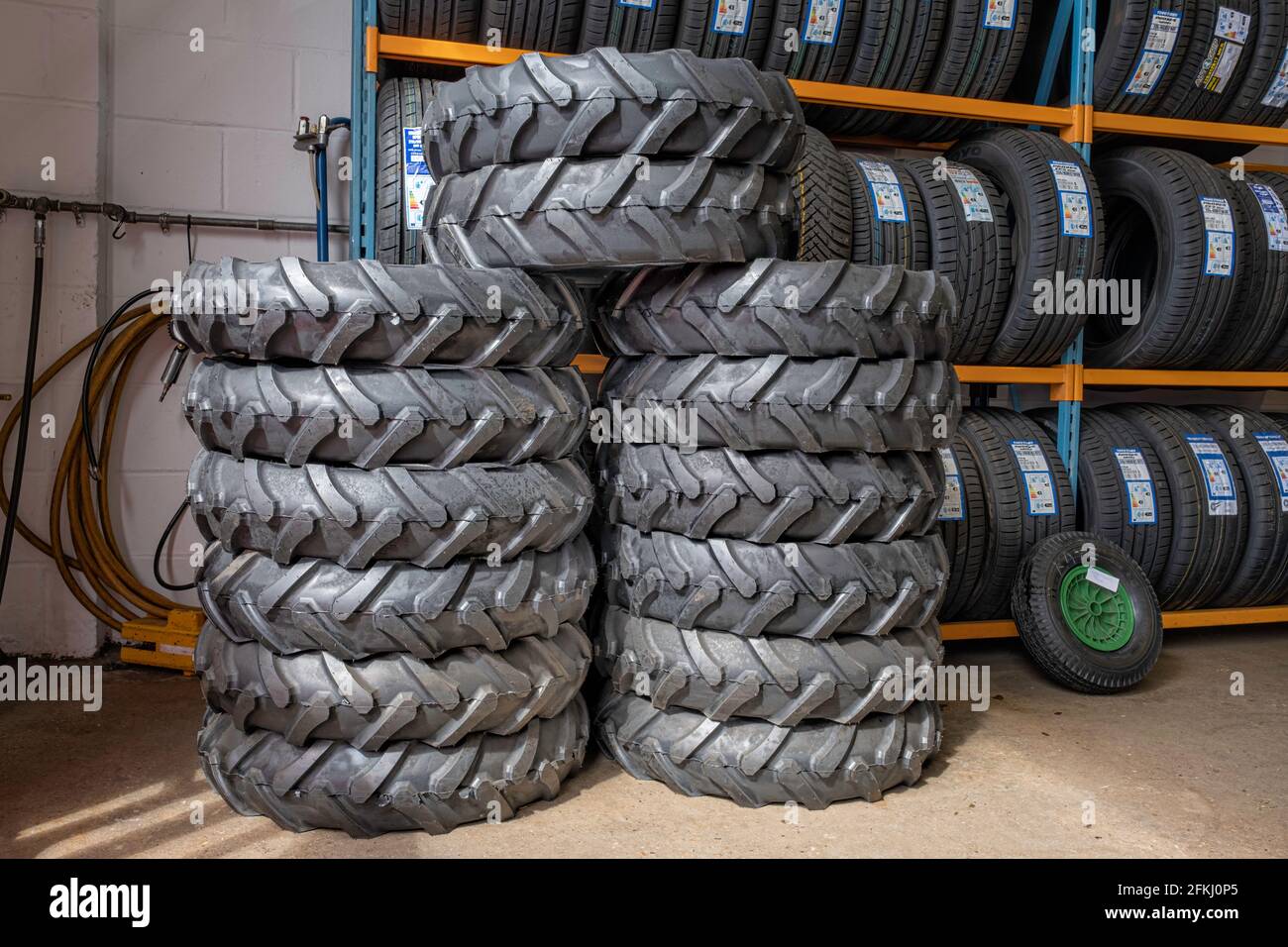 Group of agricultural implement tyres stacked at the entrance of a tyre ...