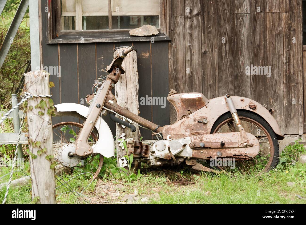 Kowada, Shizuoka, Japan, 04-22-2021, Abandoned rusted motorbike outside ...