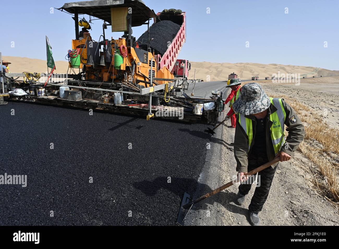 YULI, CHINA - MAY 1, 2021 - Workers lay asphalt at the construction ...