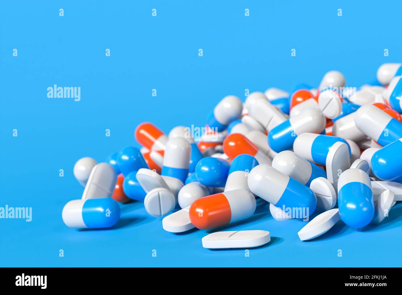 Pills in different forms and colors falling onto a blue background ...